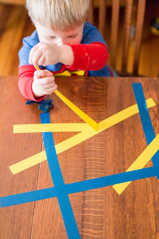 Peeling Tape Activity to Strengthen Little Toddler Fingers - HOAWG